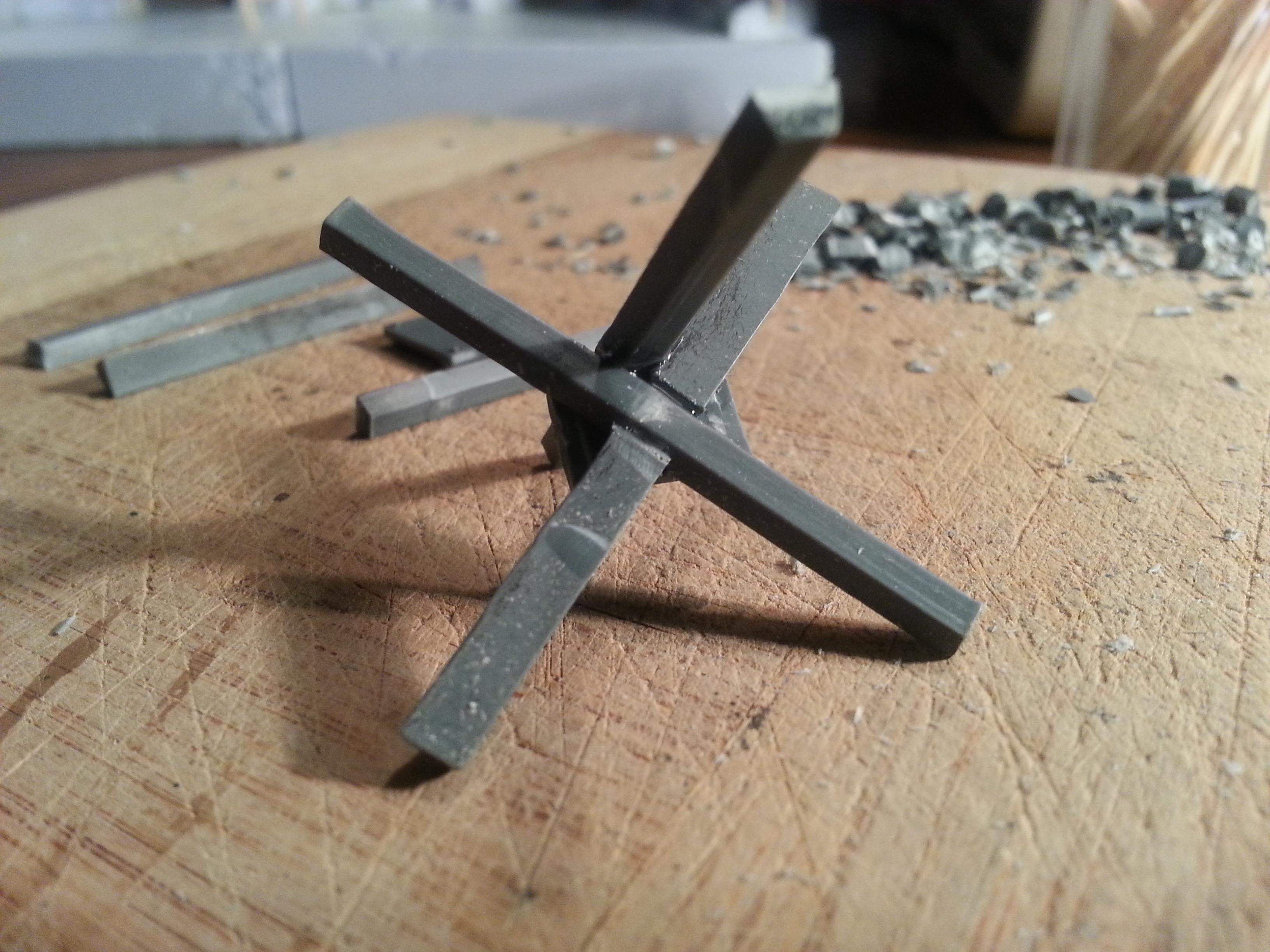 Cut a knotch in the middle of two sticks and glue them to make an X ...